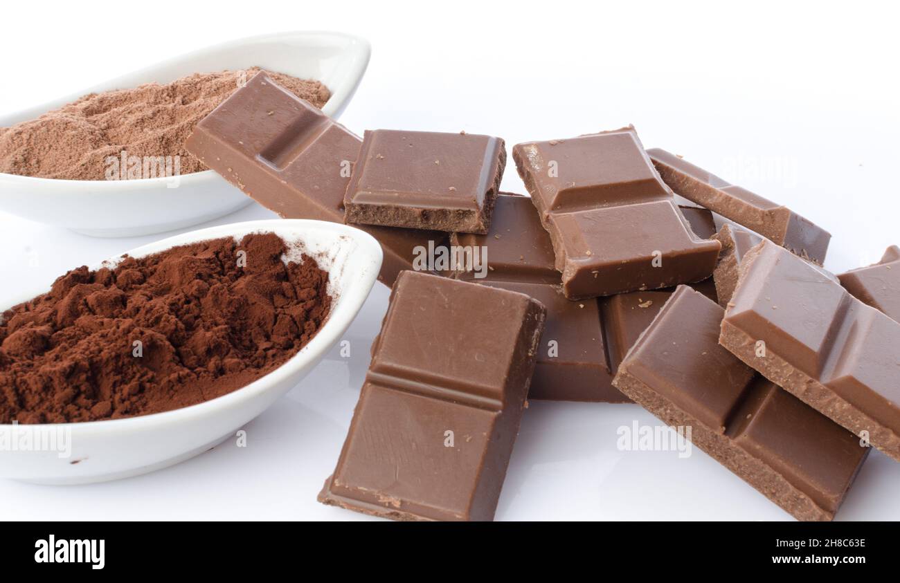 Chocolate squares and cocoa powder, isolated on white Stock Photo - Alamy