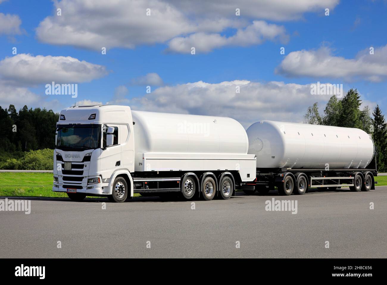 White Scania R540 heavy truck pulling tank trailer parked on truck stop ...