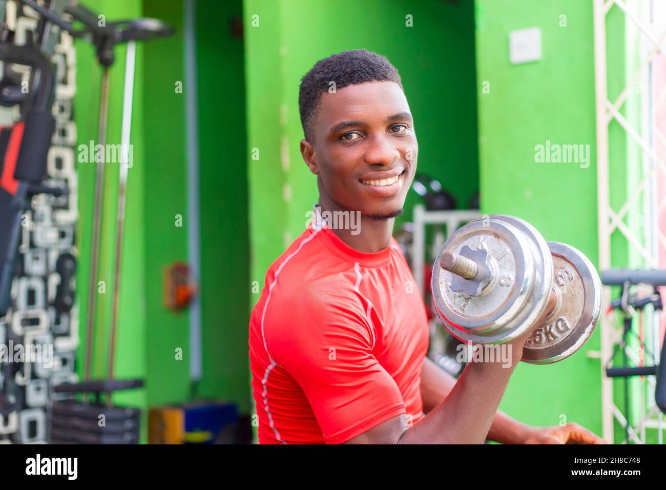 happy bodybuilder feeling excited as he is pumping dumbbell while ...