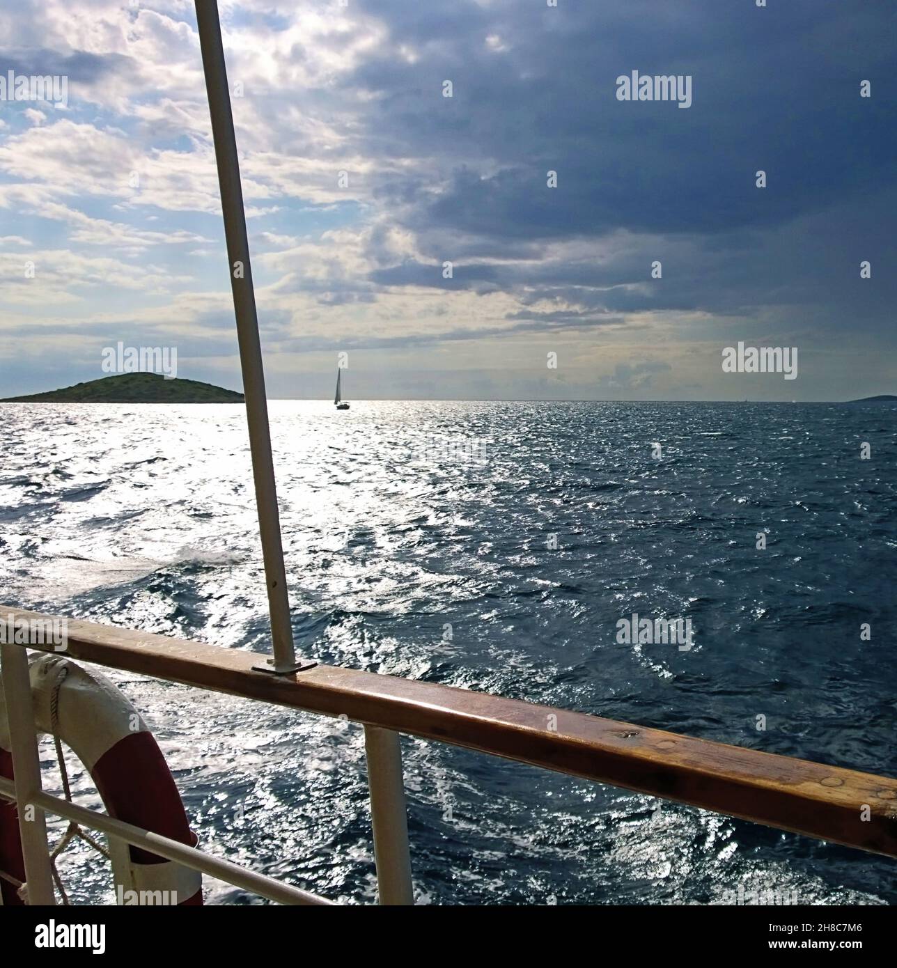 View of the sea with a boat from a ship Stock Photo - Alamy