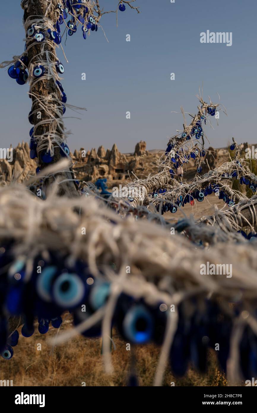 Eerie scenery of evil eye superstitious symbols on tree in Cappadocia ...