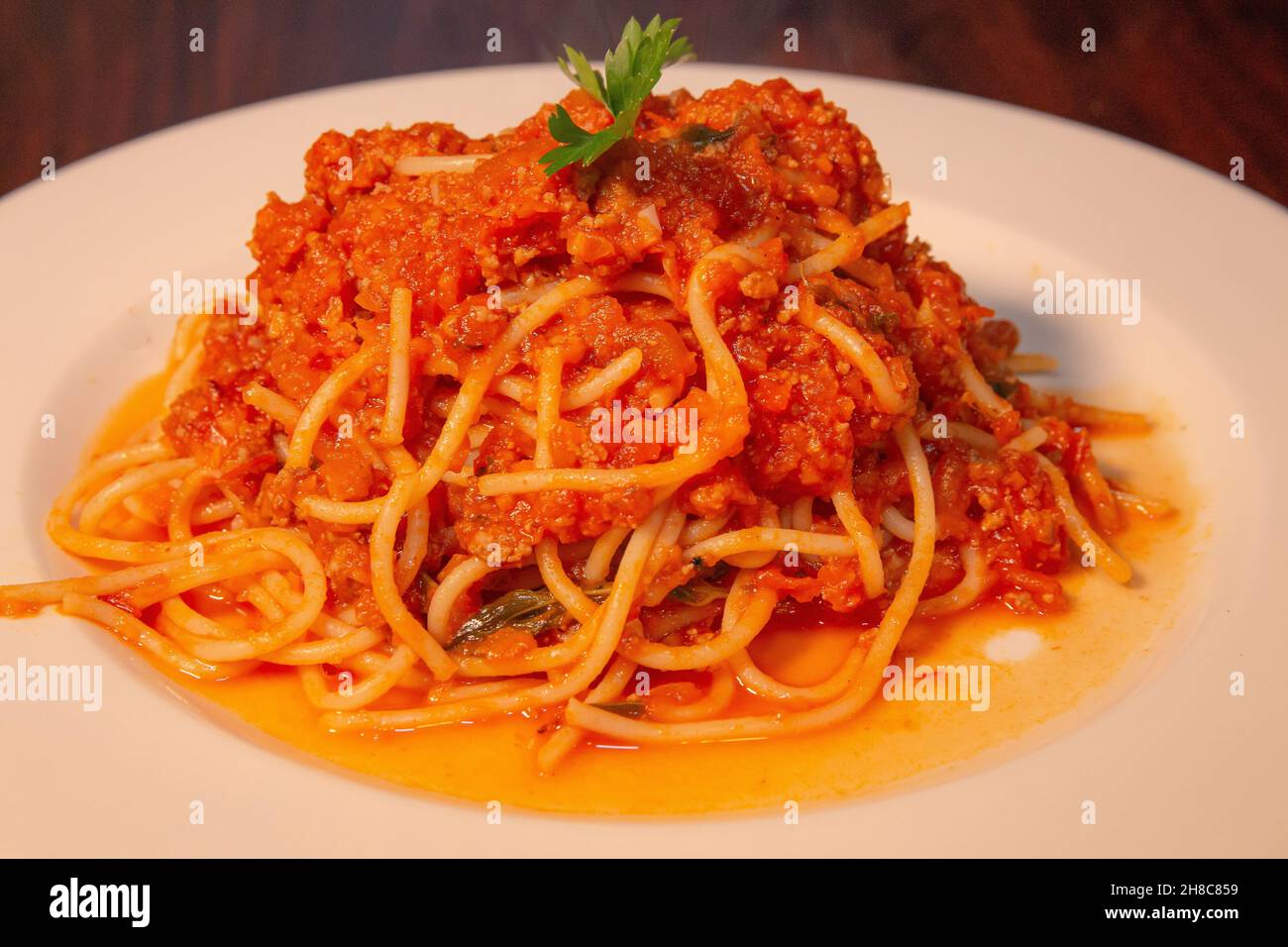 Saucy and tasty spaghetti on a white plate Stock Photo - Alamy