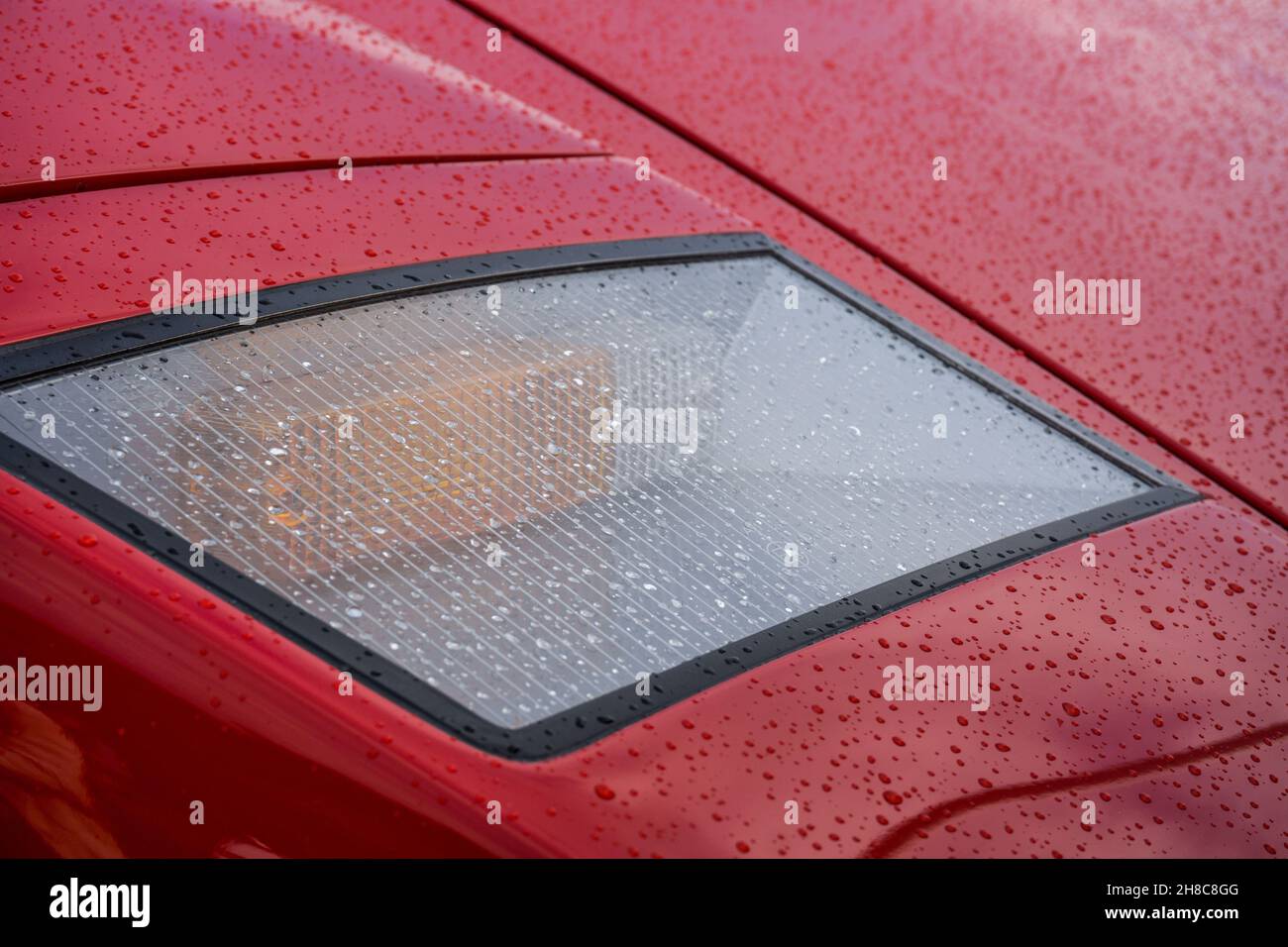 Close up detail of the headlight and bonnet on a red Lamborghini ...