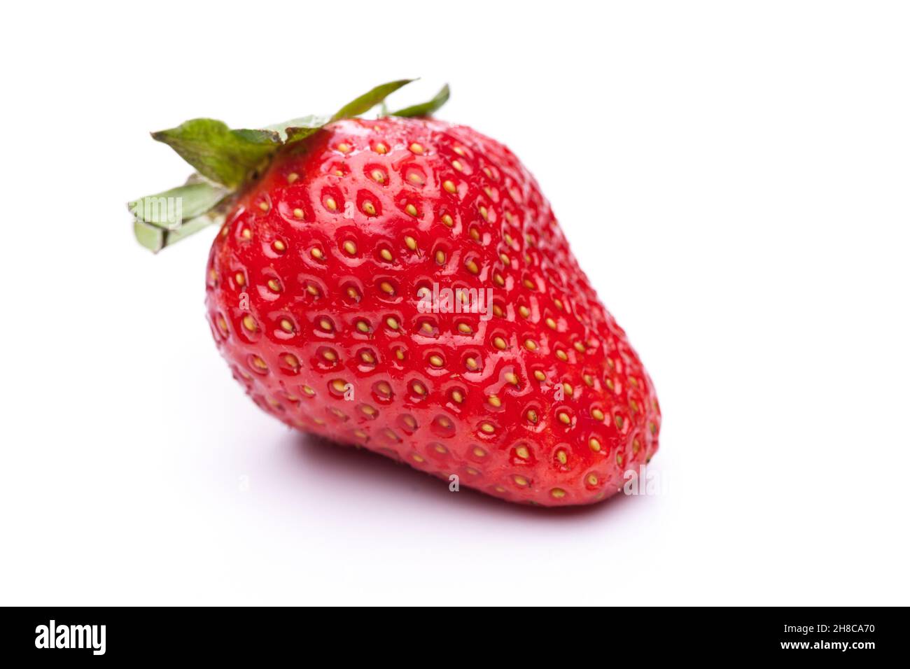 A single strawberry isolated on white background Stock Photo - Alamy