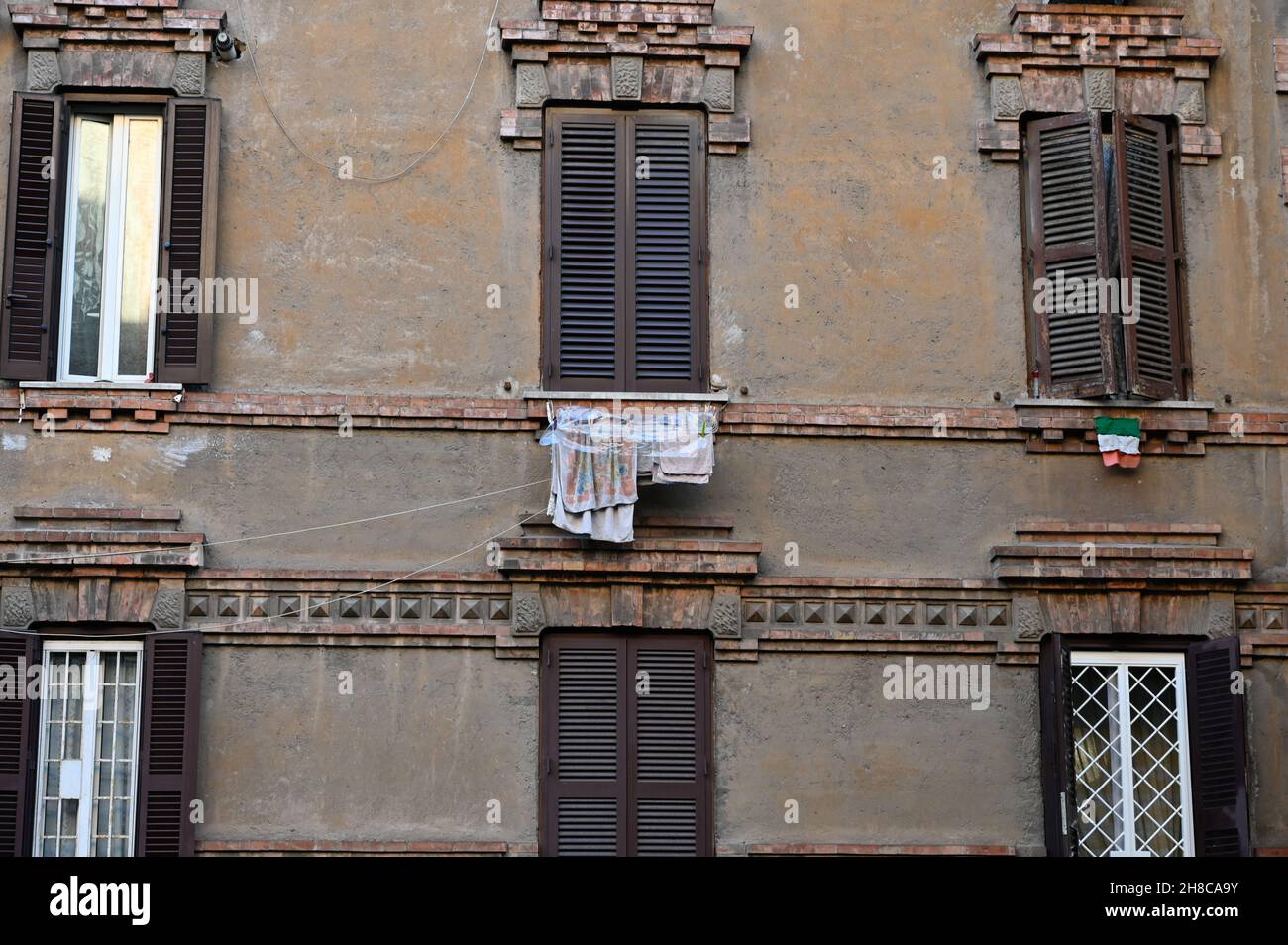 A typical old Italian house with a clothesline between the windows ...