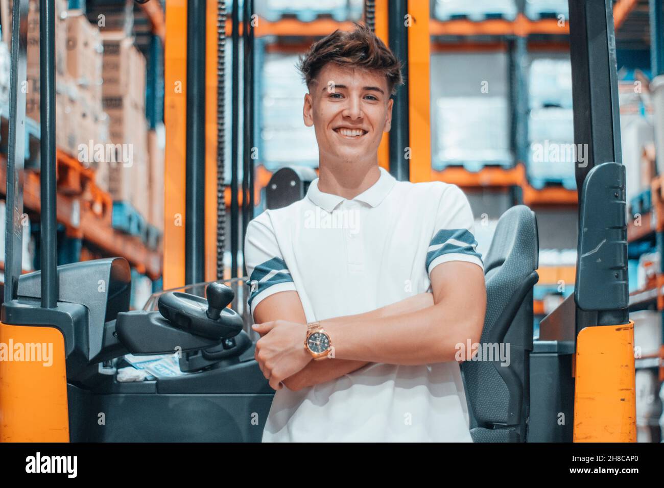 Smiling manager boy in warehouse checking safety rules with machines ...