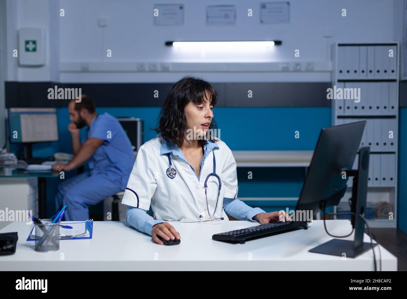 Doctor on shift typing hi-res stock photography and images - Alamy