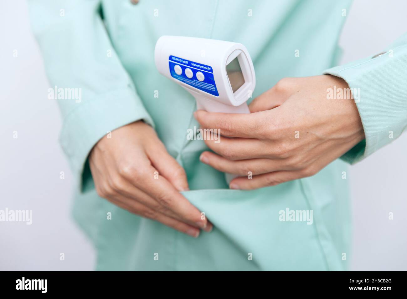 Temperature measurement gun in doctor hands. Close-up shot of doctor ...