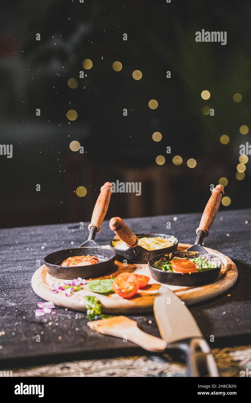 Vertical shot of raclette spread with sliced veggies Stock Photo - Alamy