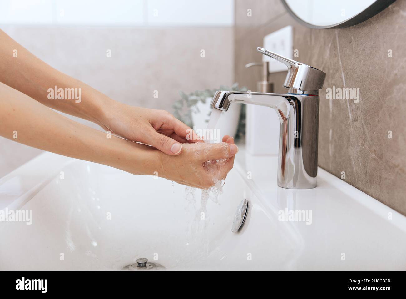 Washing hands under the flowing water tap. Hygiene concept hand detail ...