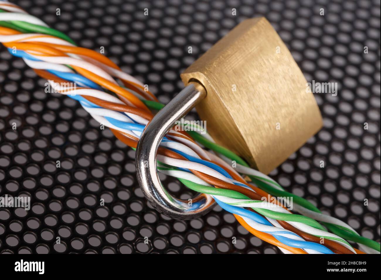 A bundle of colored, twisted wires are passed through a closed lock ...