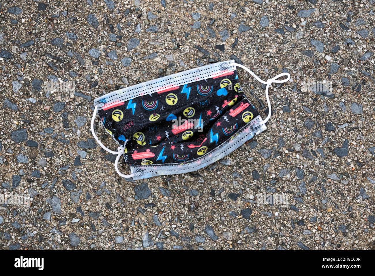 A discarded face mask, likely a child's, on the pavement in Queens, New ...