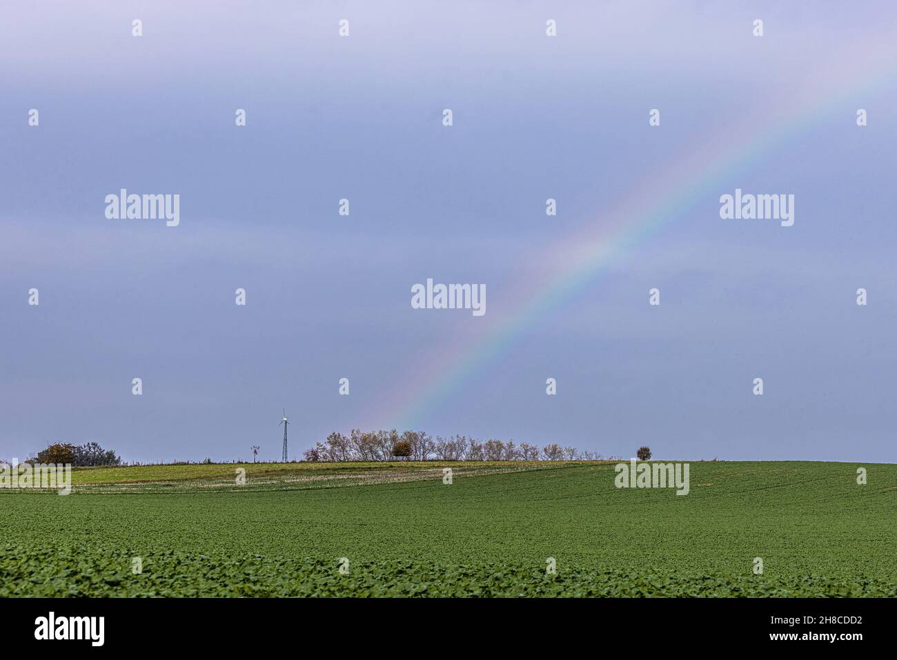 small wind wheel in field landscape with rainbow, Germany, Bavaria ...