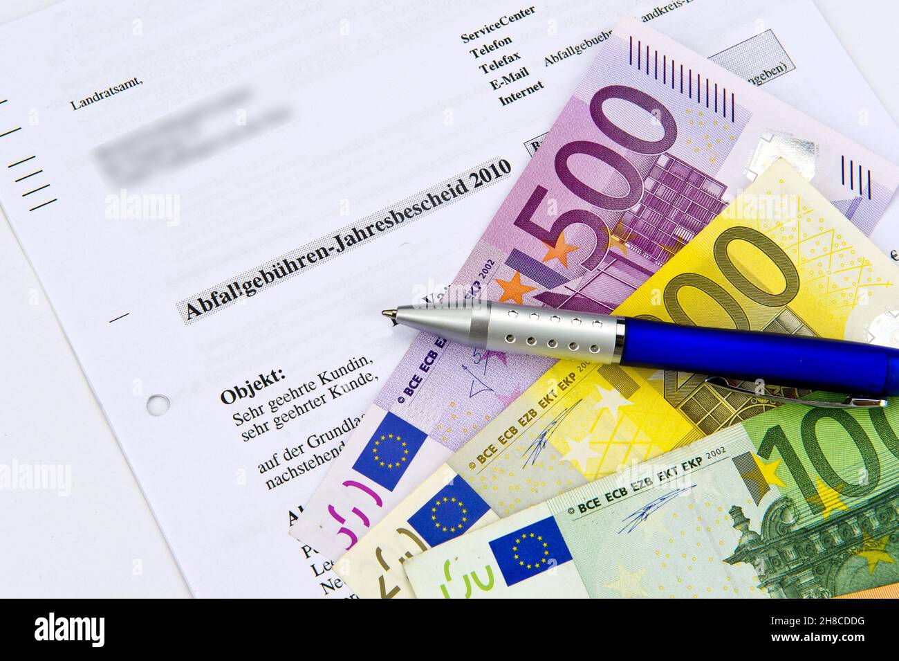 German price increase of waste collection fees with Euro bills and ...