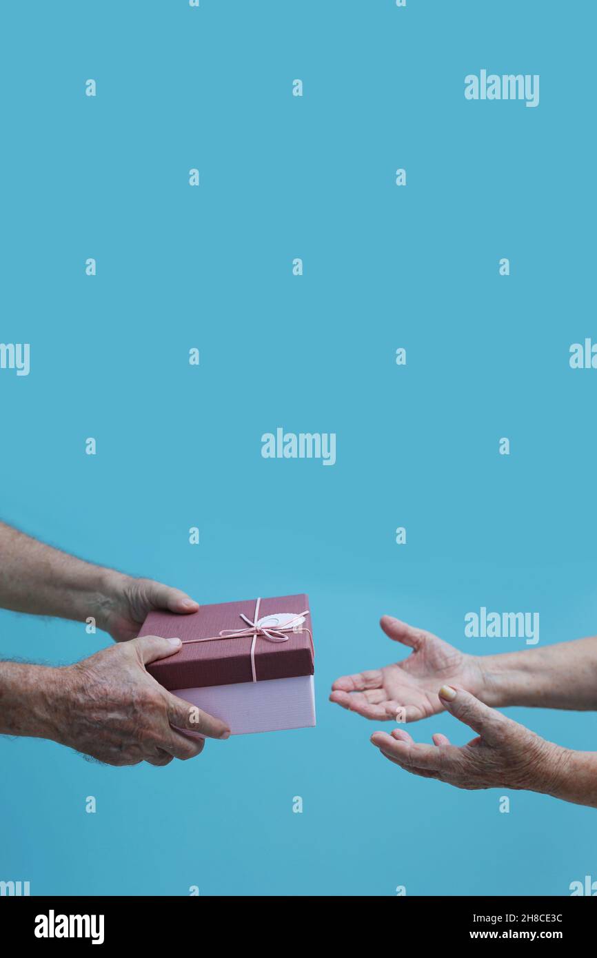 Hand offering gift to another hand hi-res stock photography and images ...