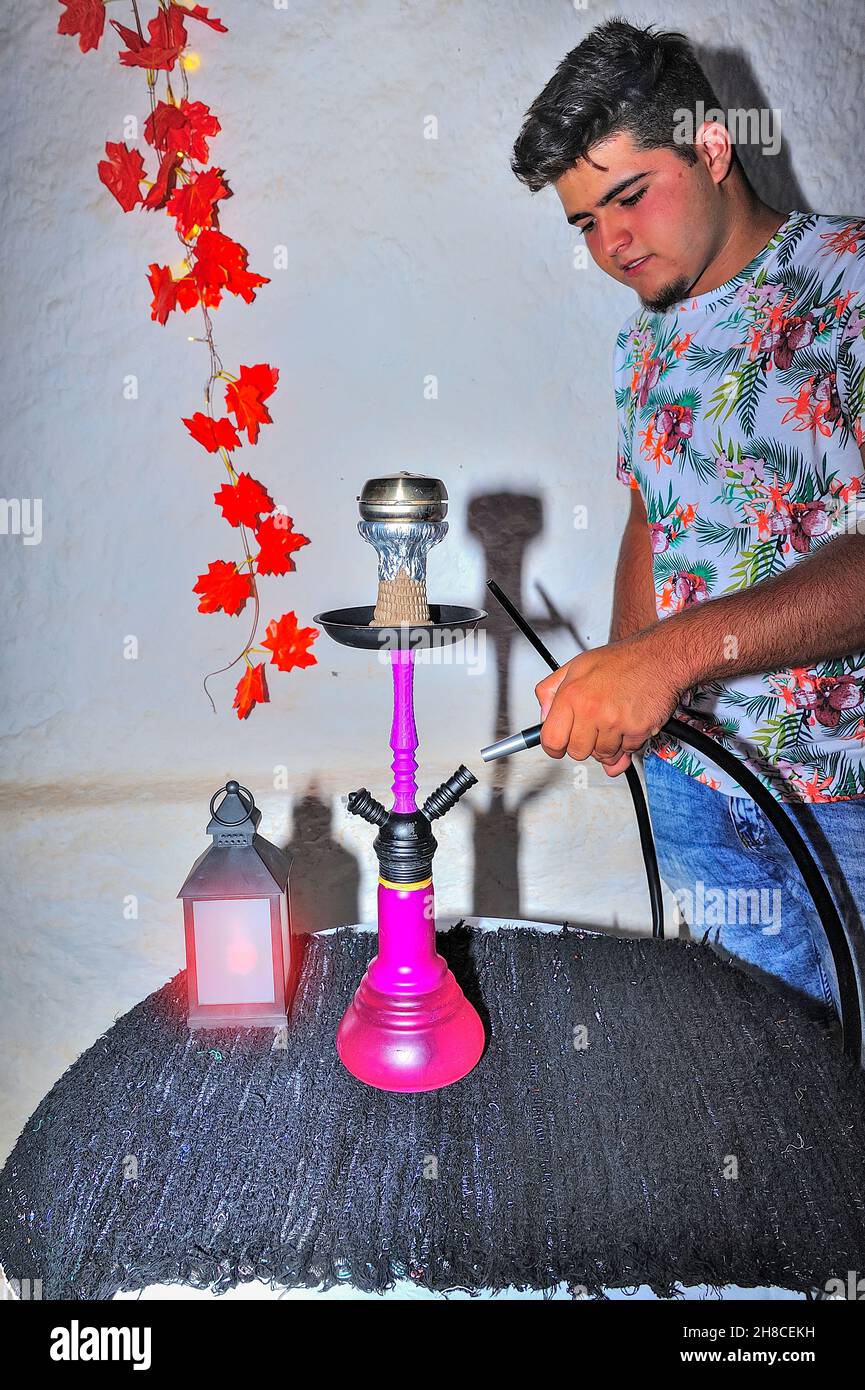 Preparation of a hookah on the terrace of a Pub Stock Photo - Alamy