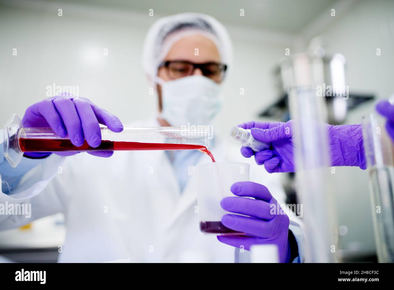 Doctor and laboratory technician doing blood analysis. Using measuring ...
