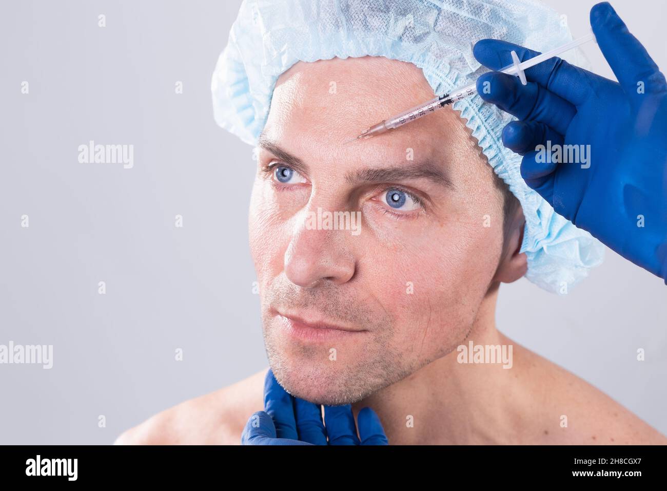Plastic surgery concept. Man receiving injection in his face. Trendy ...