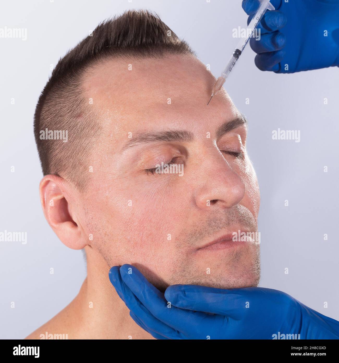 Plastic surgery concept. Man receiving injection in his face. Trendy ...