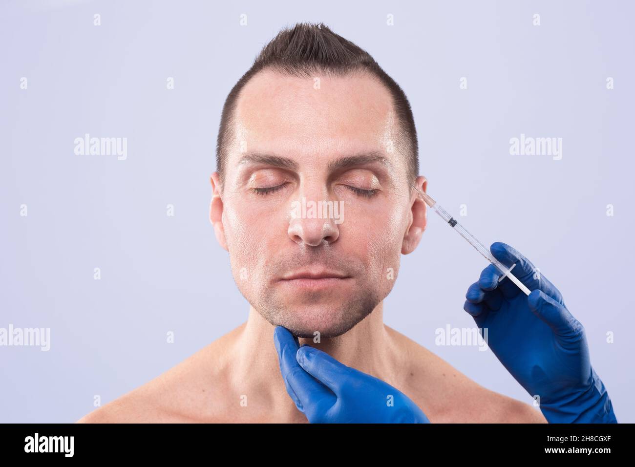 Plastic surgery concept. Man receiving injection in his face. Trendy cosmetics procedure for men ...