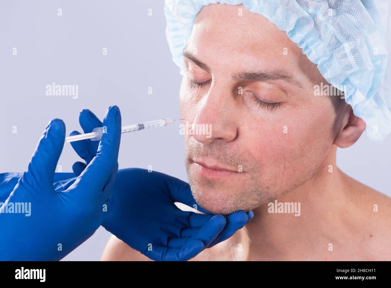 Plastic surgery concept. Man receiving injection in his face. Trendy ...