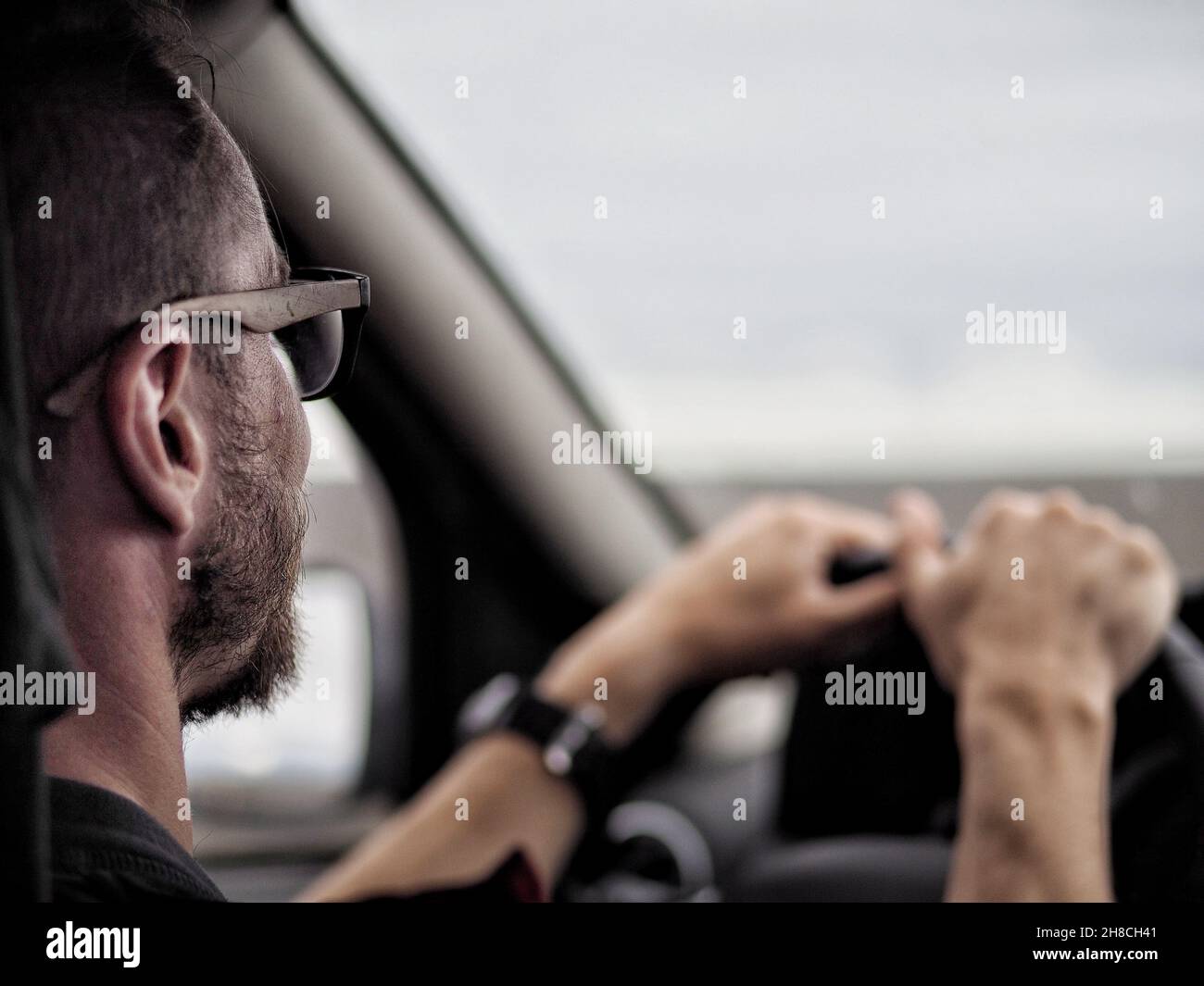 Over the shoulder image of businessman driving the car Stock Photo - Alamy