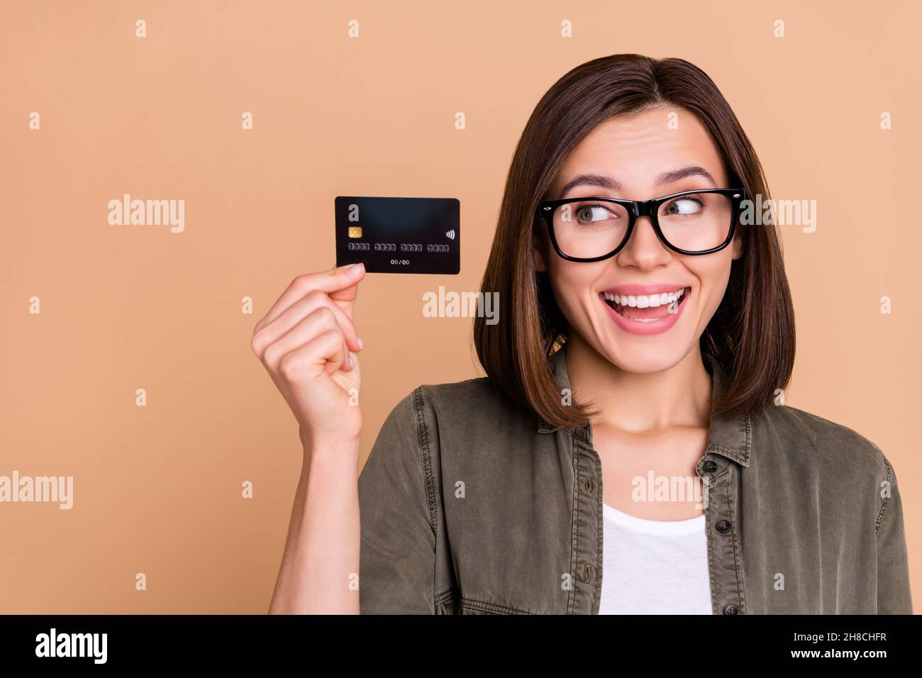 Photo of curious funny lady presenting plastic debit card wear specs ...
