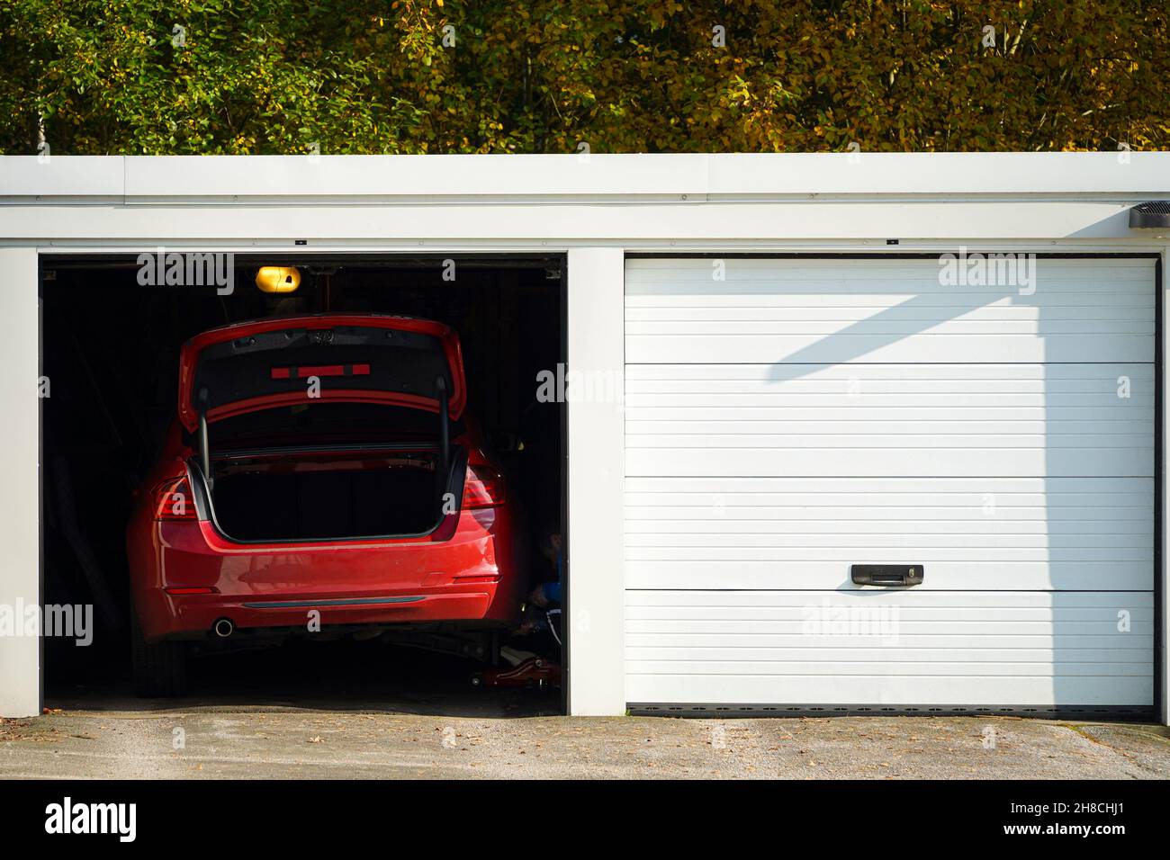 Car repair mechanic fixing auto. Man working on car in garage. At home ...
