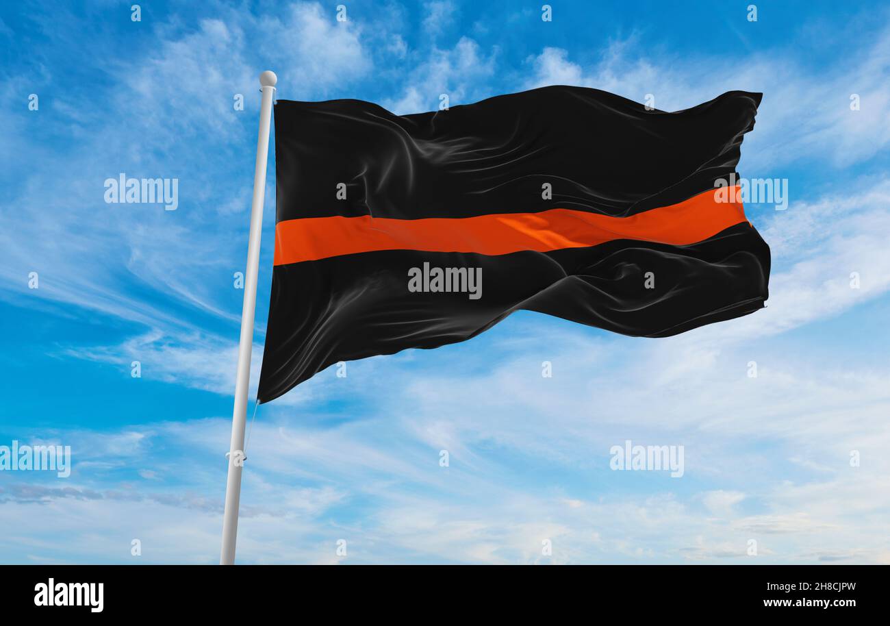 Thin Orange Line flag waving at sky background on sunset, panoramic ...