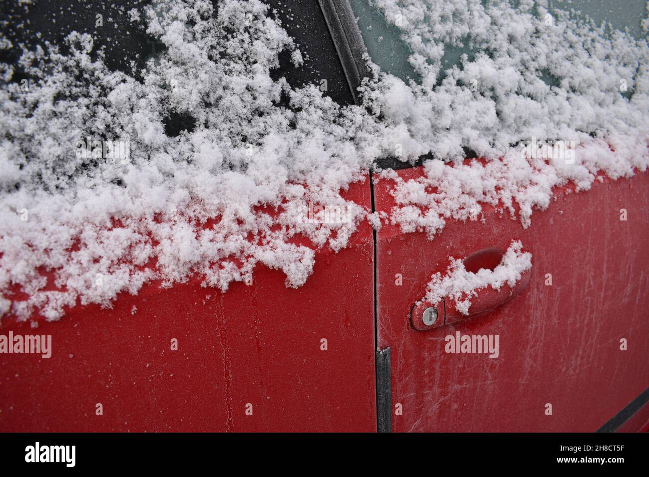 Snow on a car door handle Stock Photo - Alamy