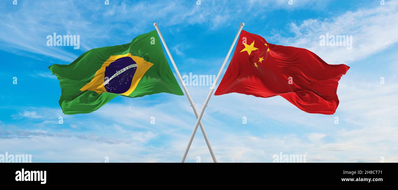 crossed national flags of Brazil and china flag waving in the wind at ...