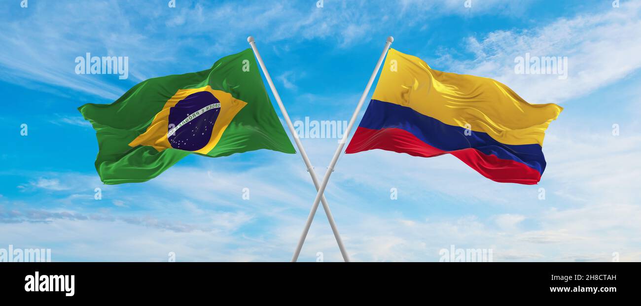 crossed national flags of Brazil and Colombia flag waving in the wind ...