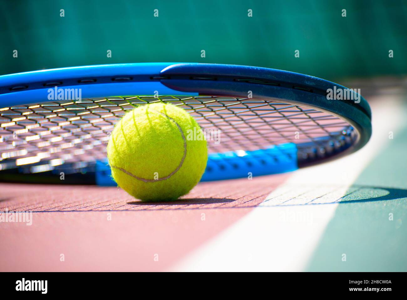 Tennis racquet and ball lying on the court. Healthy lifestyle concept ...