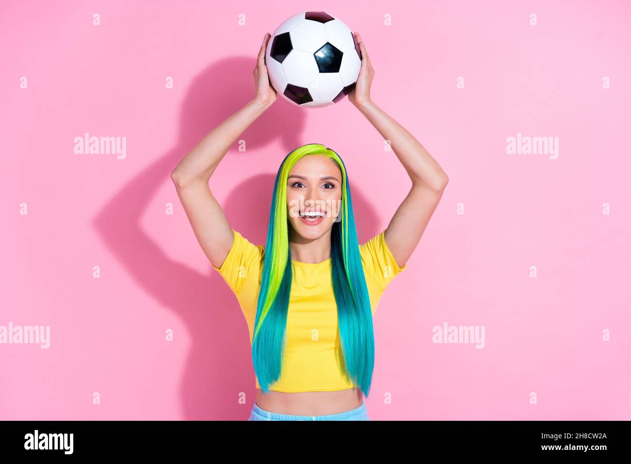 Portrait of smiling excited girl catch football big fan support with ...