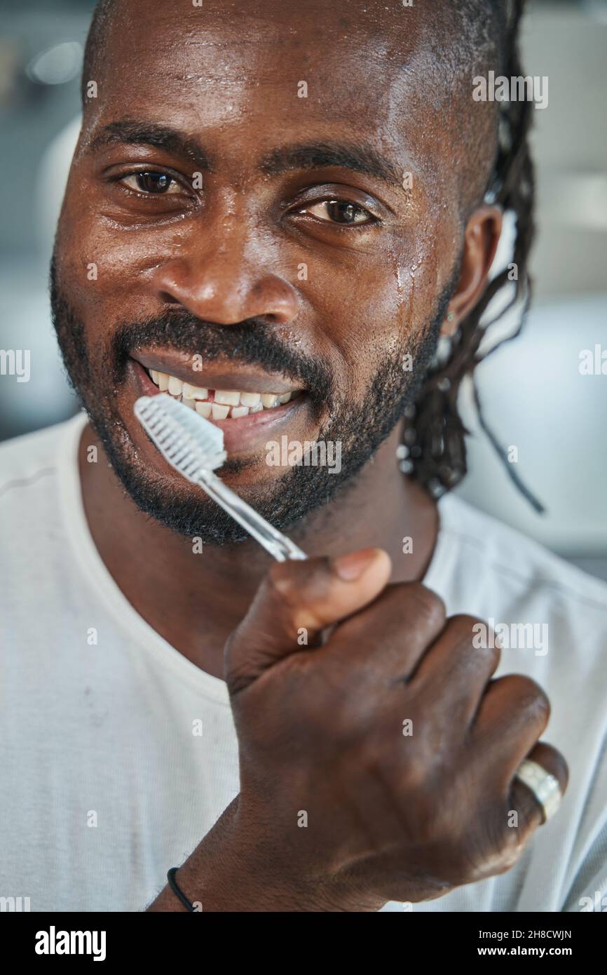 Young African American male brushing his teeth Stock Photo - Alamy