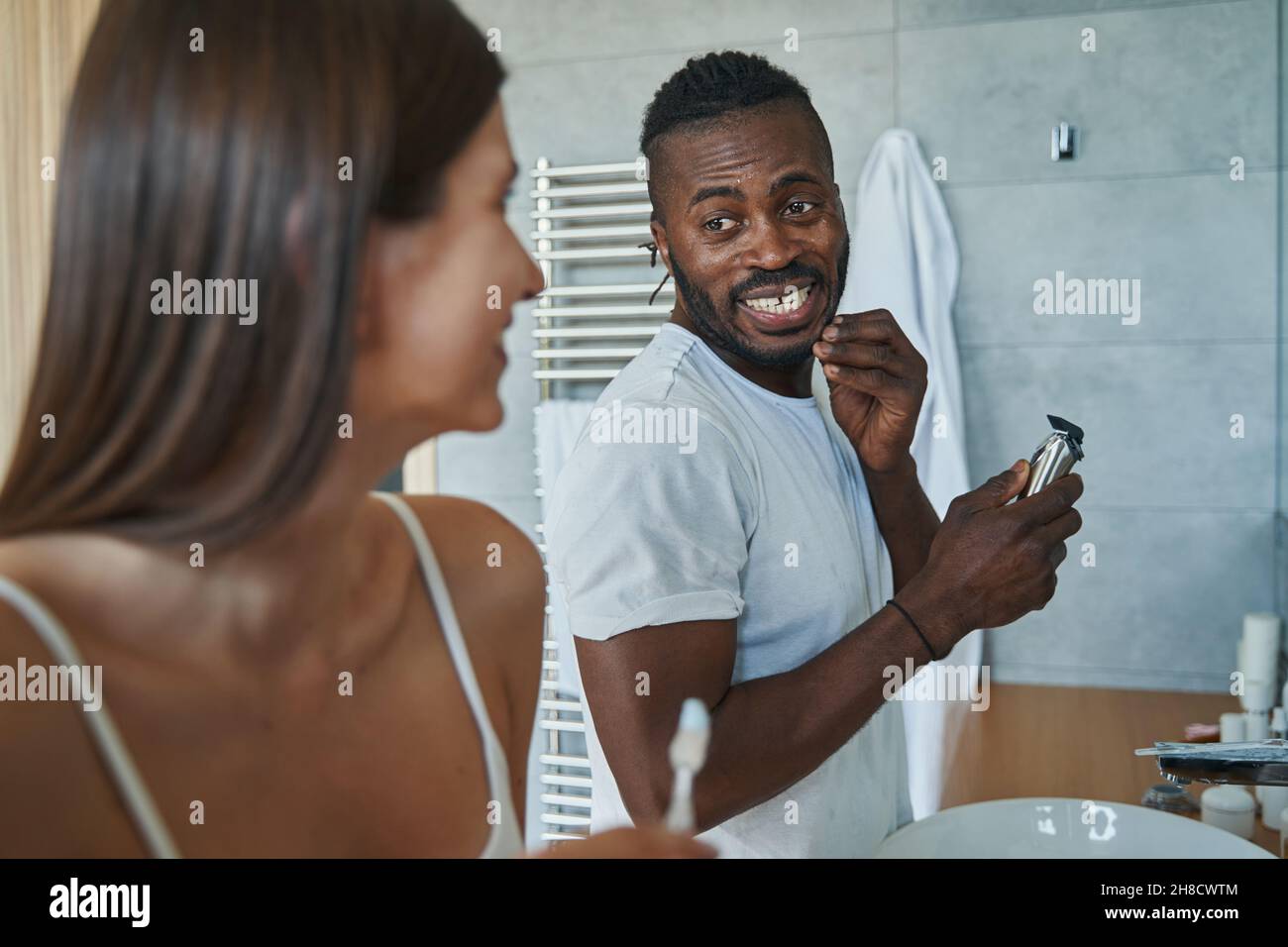 Couple standing in bathroom during morning hygiene procedures Stock ...