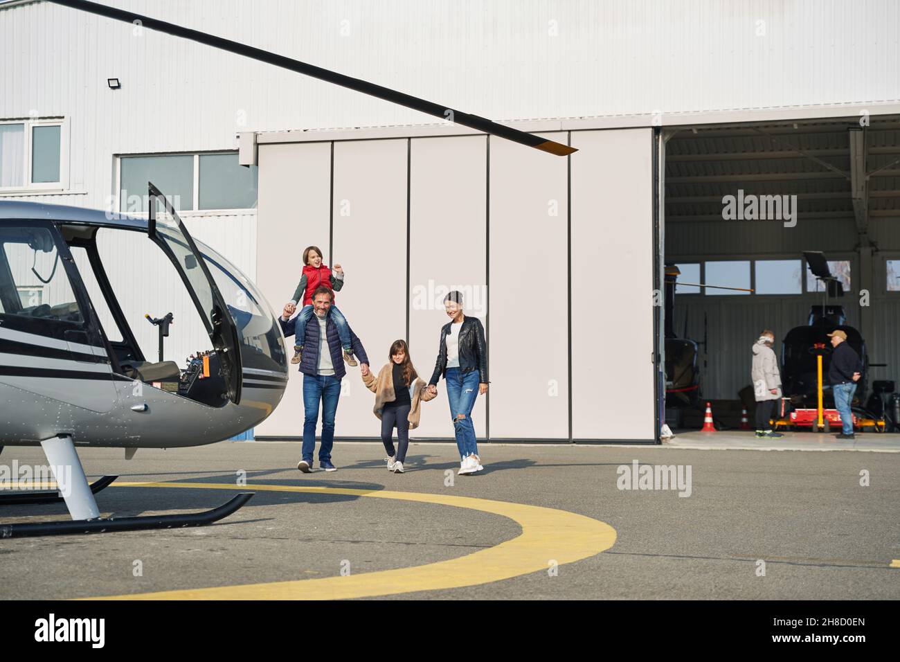 Lovely family with kids walking on an airfield together Stock Photo - Alamy