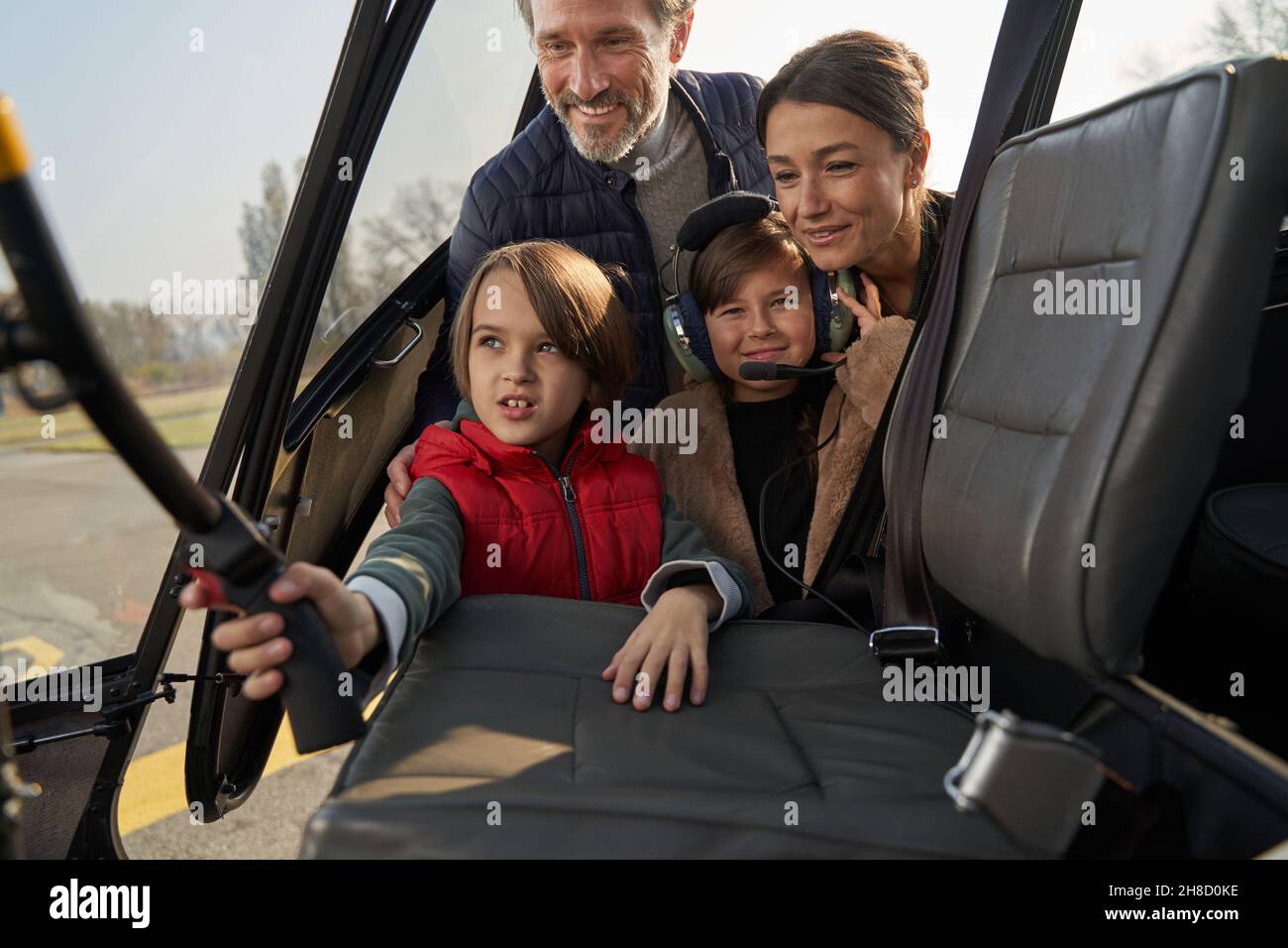 Curious children and their parents exploring in the helicopter Stock ...