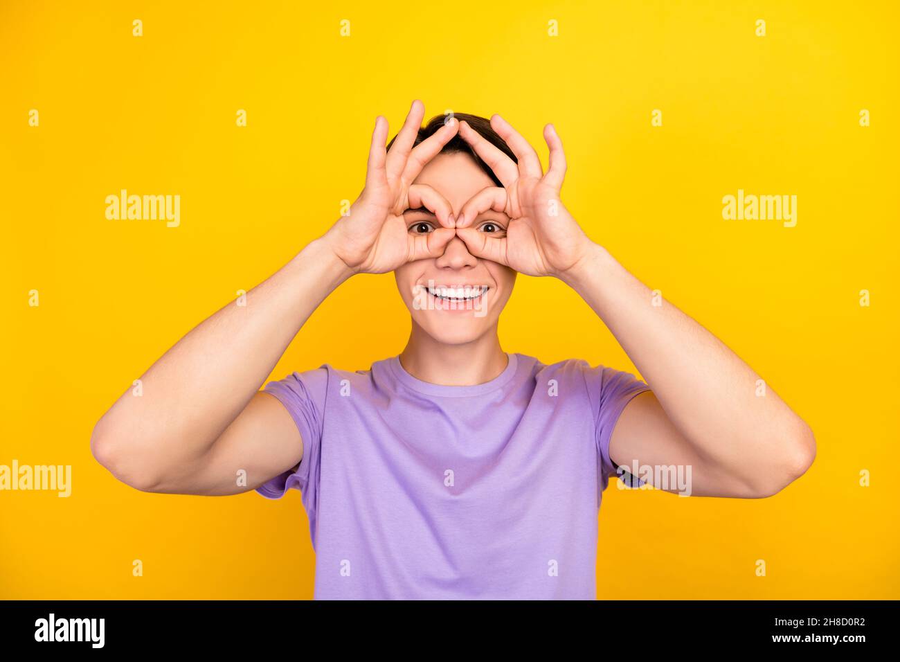 Portrait of attractive cheerful funny guy showing ok-sign like glasses ...