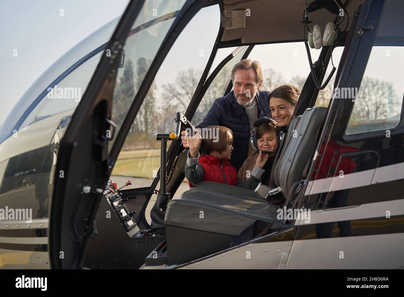 Loving parents bringing their children on a helicopter ride Stock Photo ...