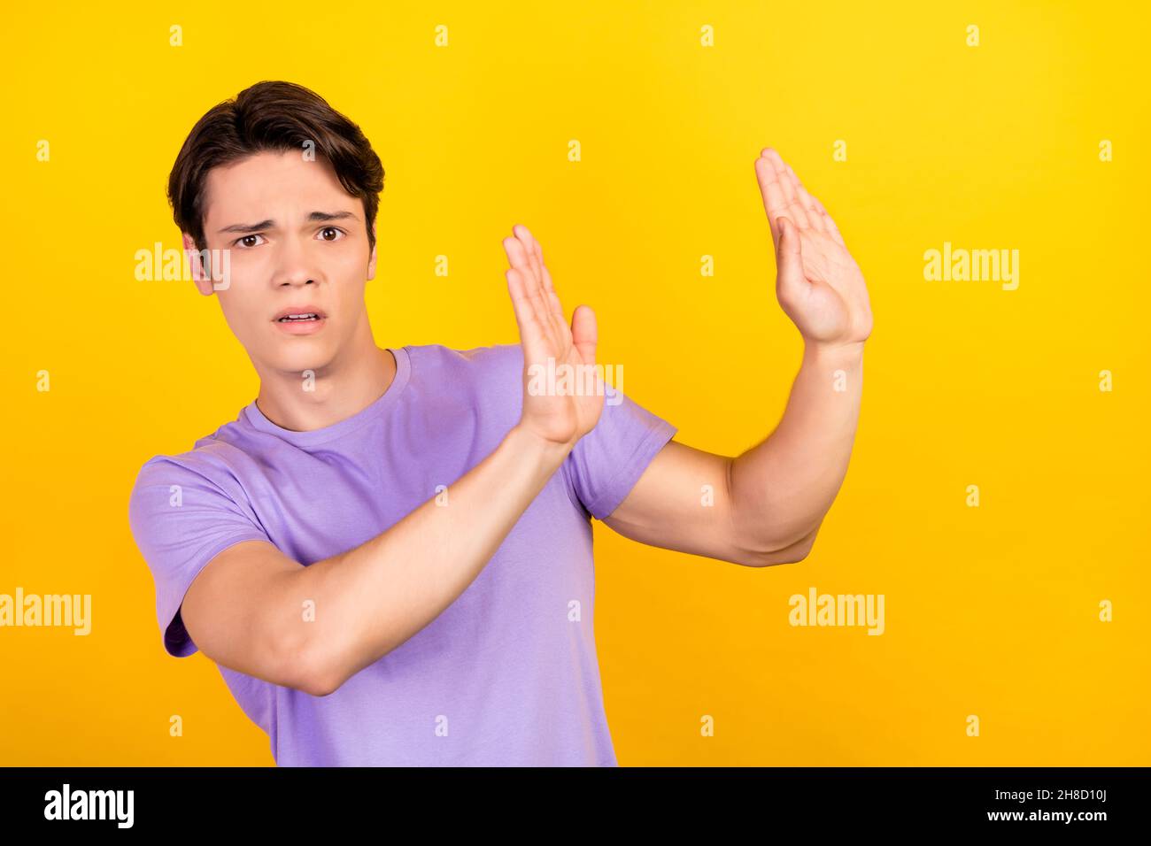 Portrait of attractive desperate guy showing stop sign protect from ...