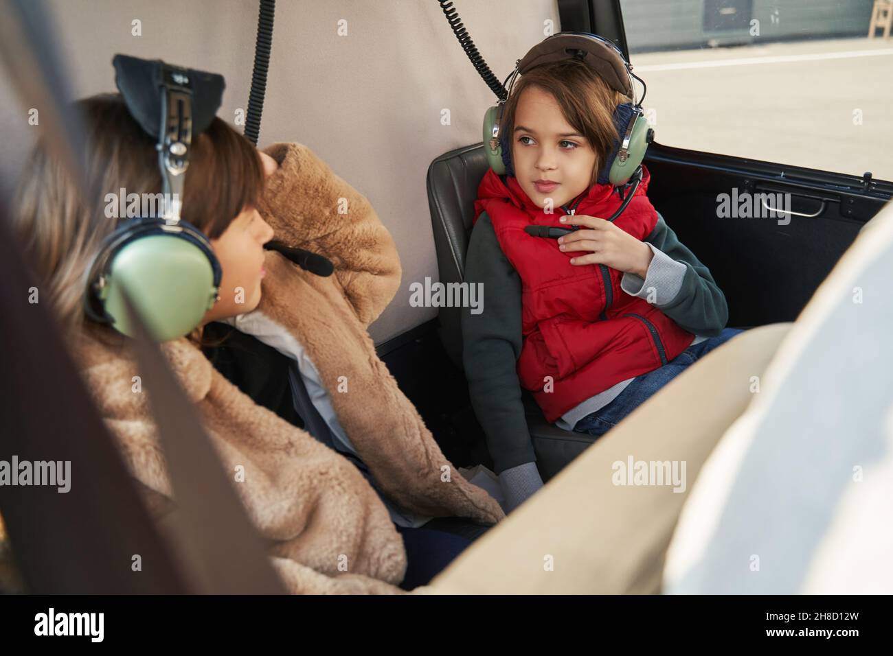 Two kid friends flying in a helicopter Stock Photo - Alamy