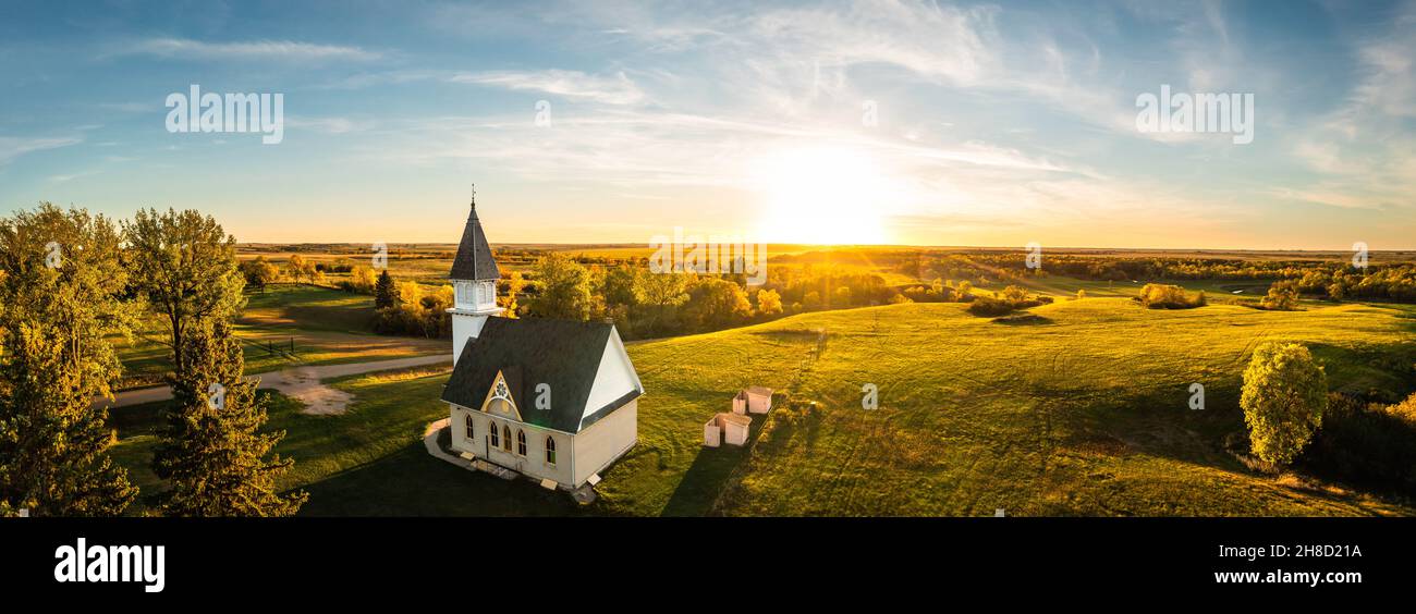 An old country church in the Great Plains during sunset with fall ...