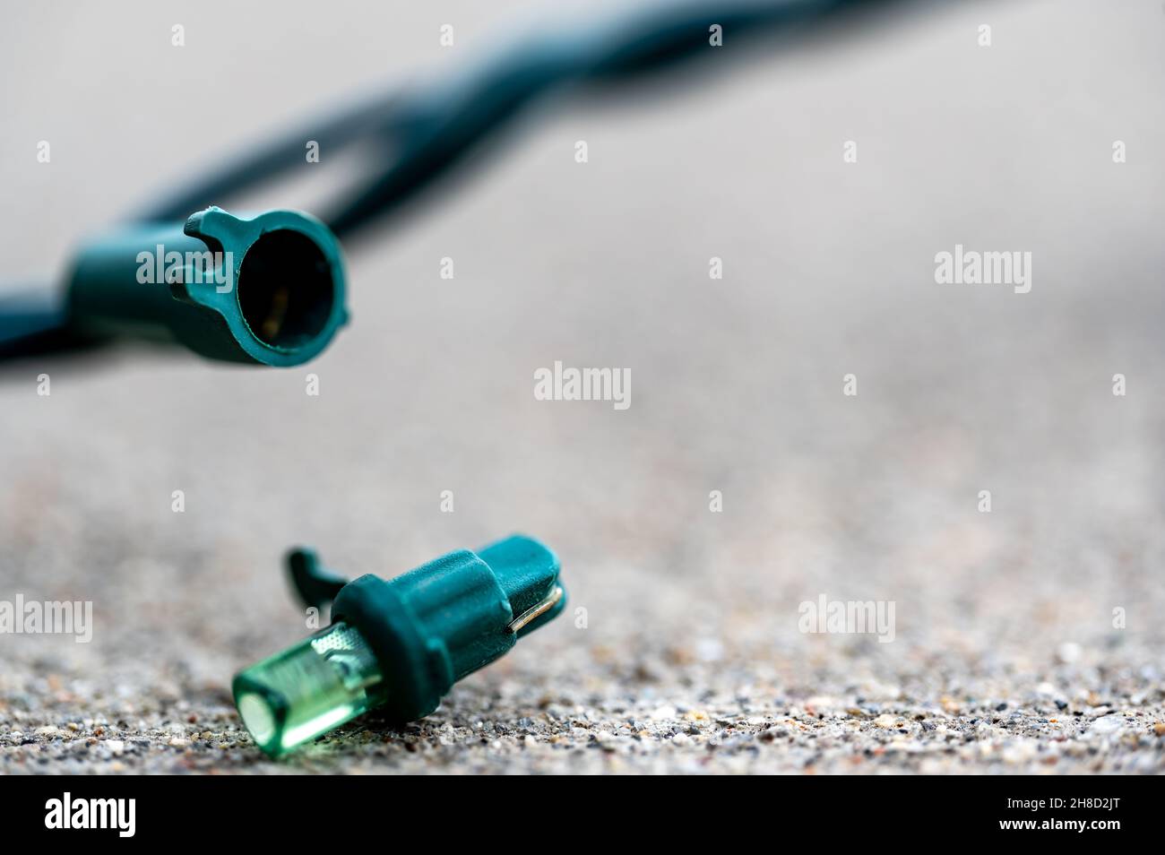 Focus on replacement bulb for a string of Christmas lights to repair a ...