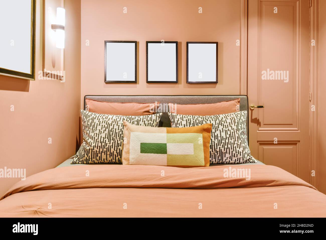 Peach bedroom with many paintings and a bed covered with a peach fluffy ...