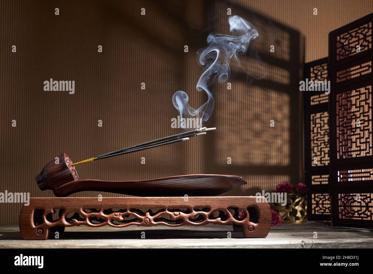 Smoke from burning incense sticks standing on lotus incense holder ...