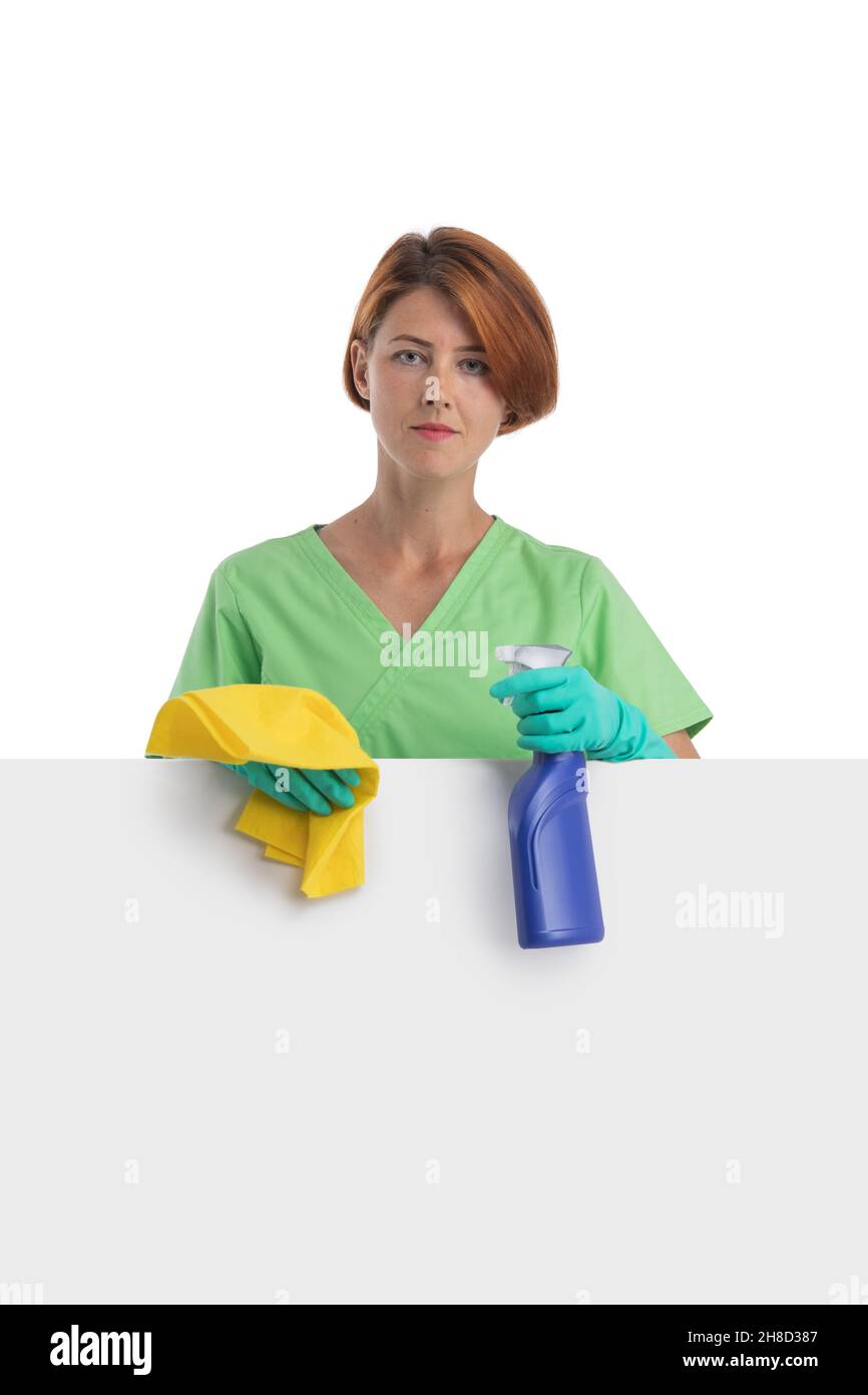 A woman cleaning lady with a rag in her hand holds detergent spray ...