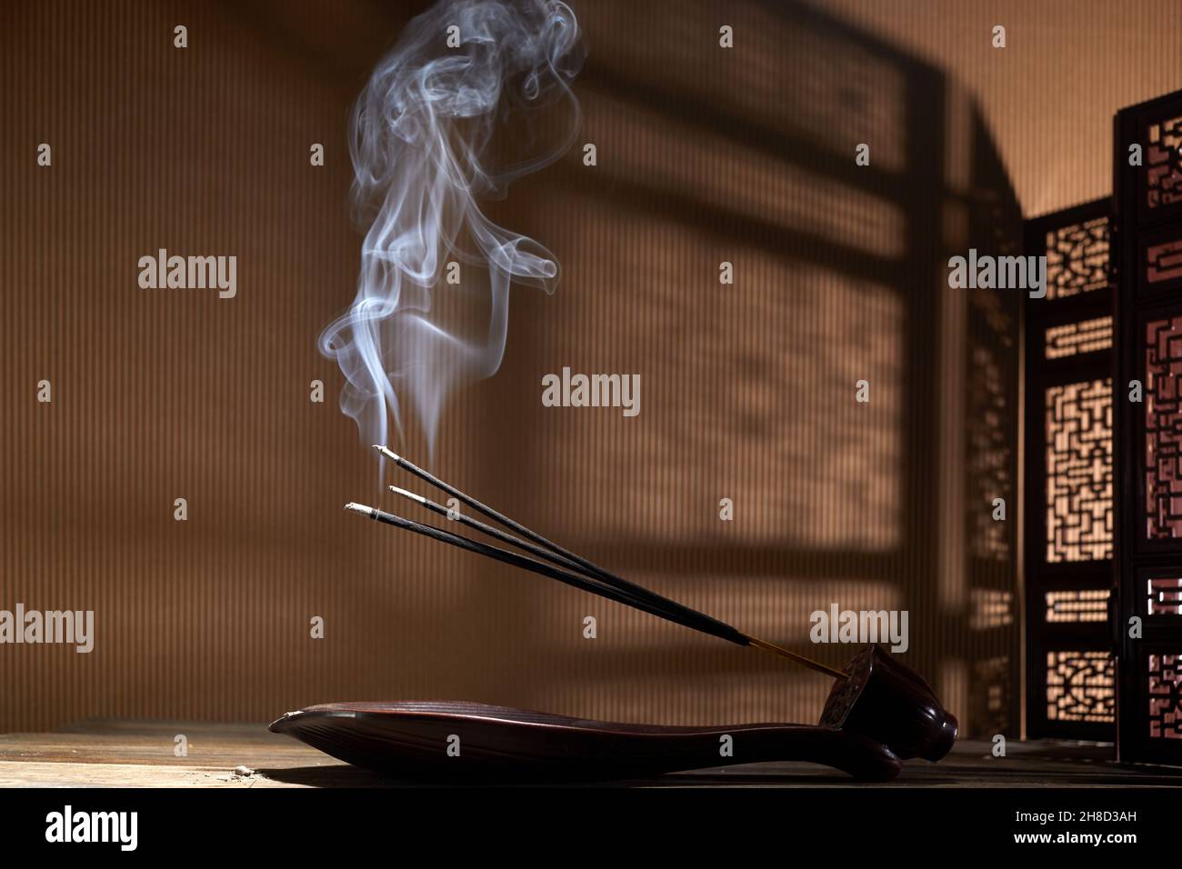 Smoke from burning incense sticks standing on lotus incense holder ...
