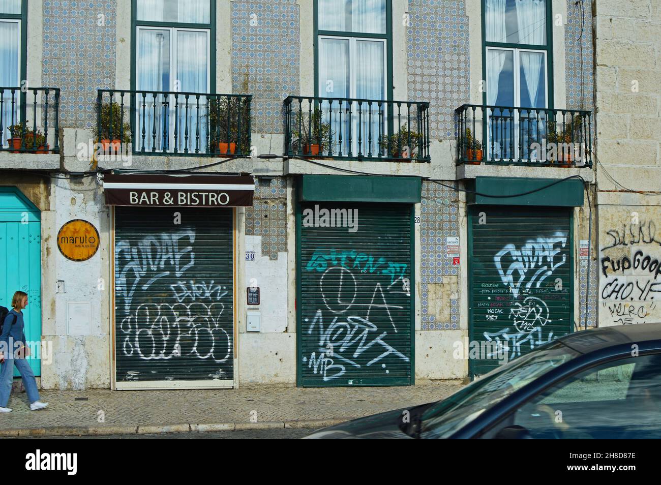 Girl and car on the background of a traditional bistro in Lisbon on the ...