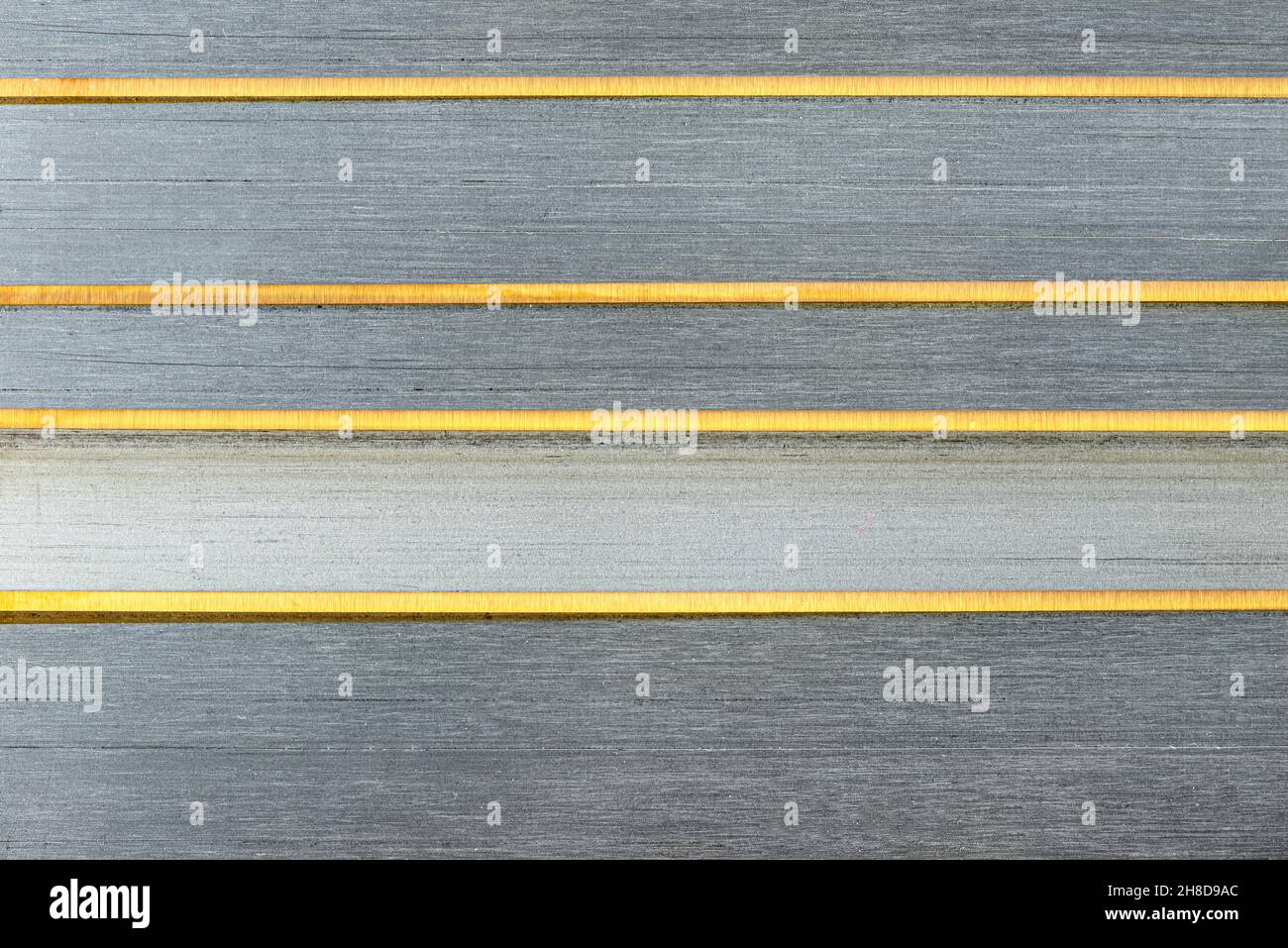 Background made from a macro photo of pile of razor blades with yellow ...